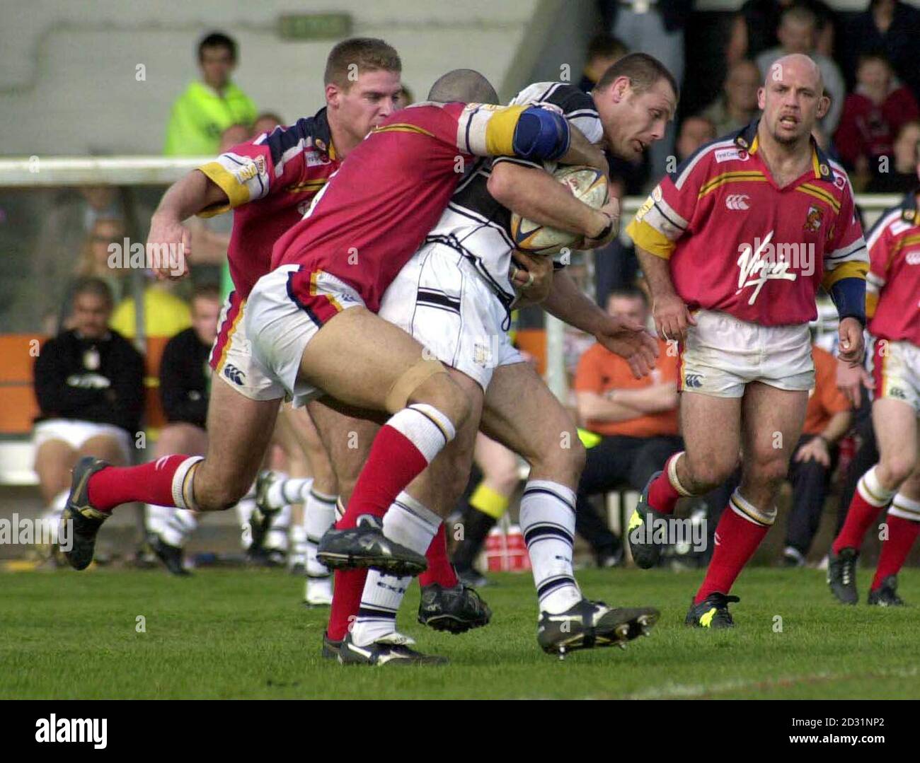Hull's Lee Jackson is tackled by London's Jim Dymock and Matt Toshack ...