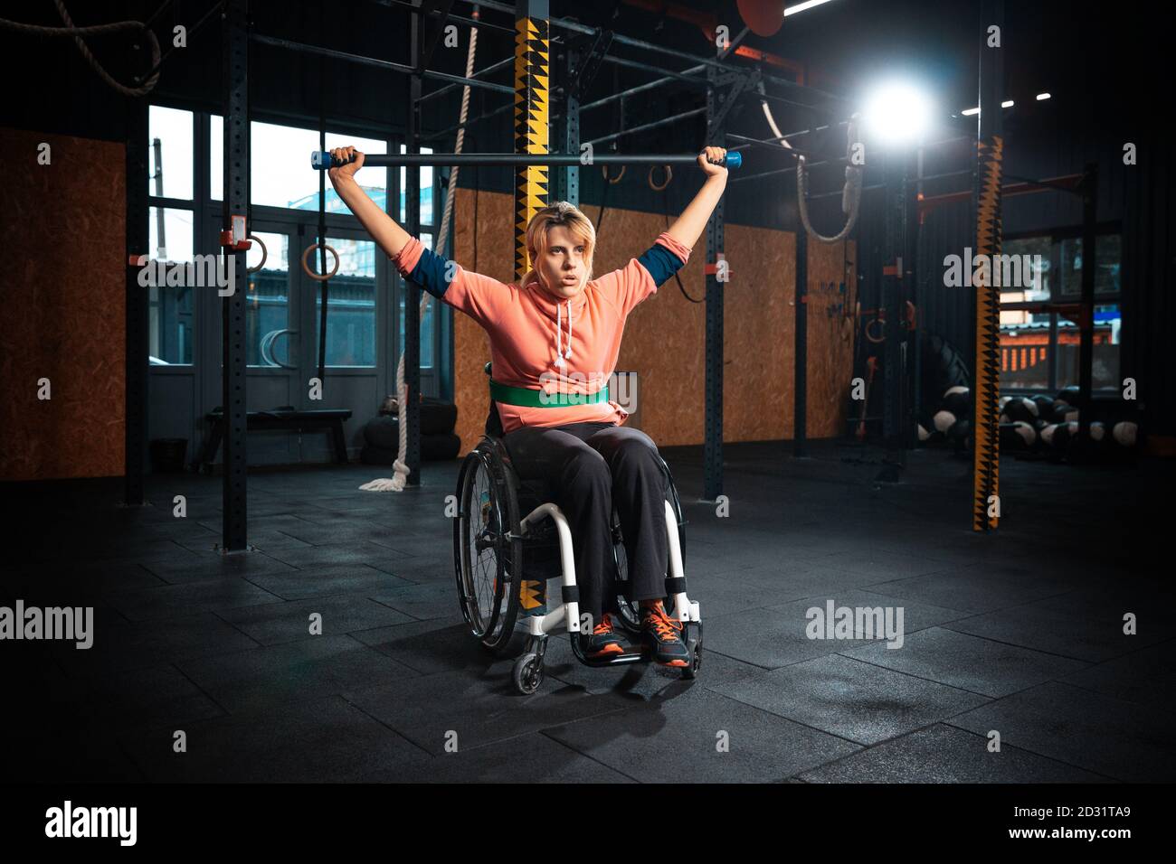 Strong. Disabled woman training in the gym of rehabilitation center ...