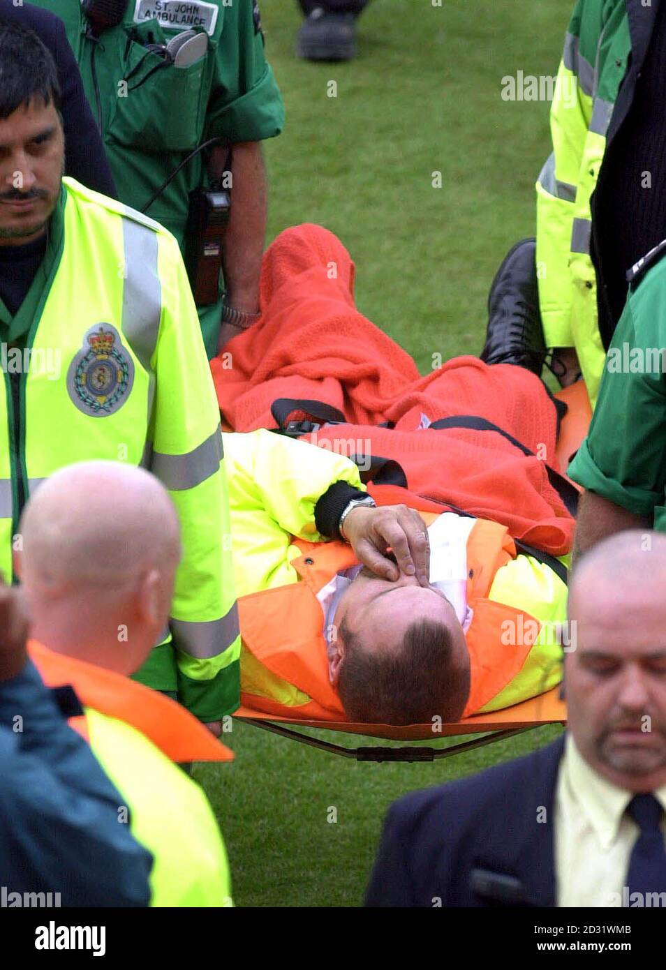 A Safety Steward lies injured after a pitch invasion stopped the ...