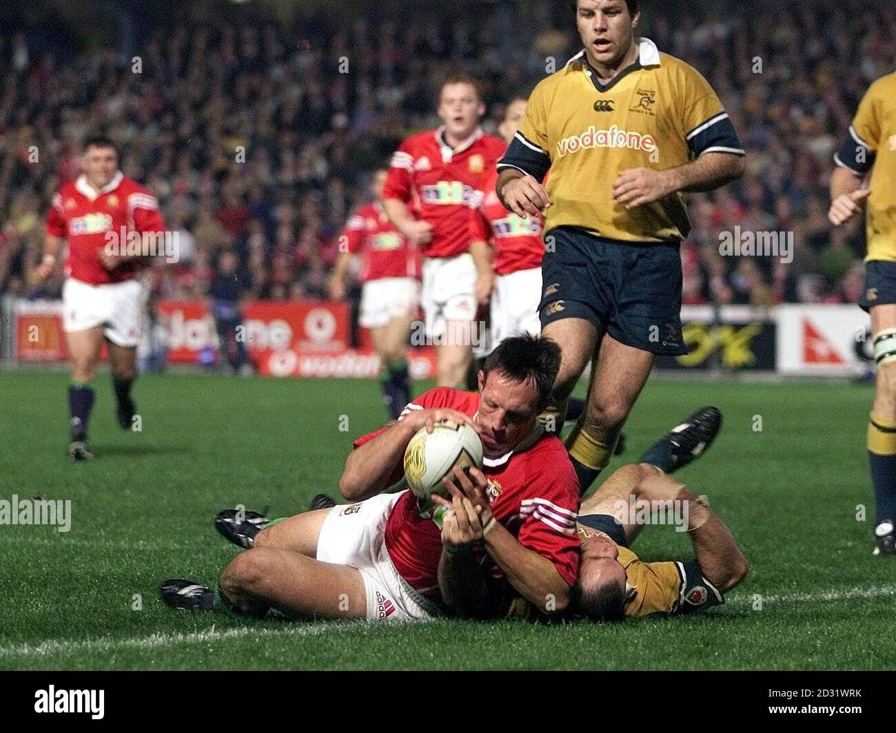 British and Irish Lions player Mark Taylor goes over to score the first ...
