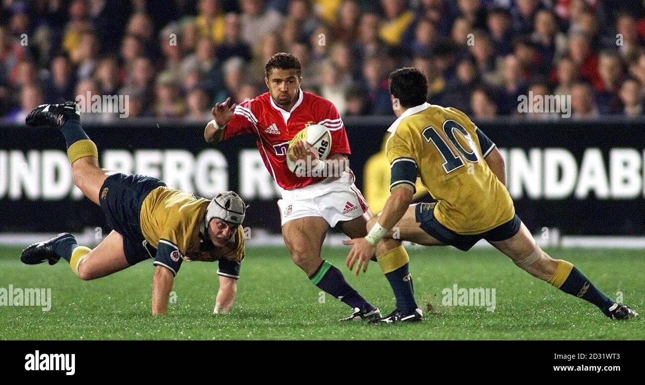 British & Irish Lions' Jason Robinson (centre) charges past Australia A ...