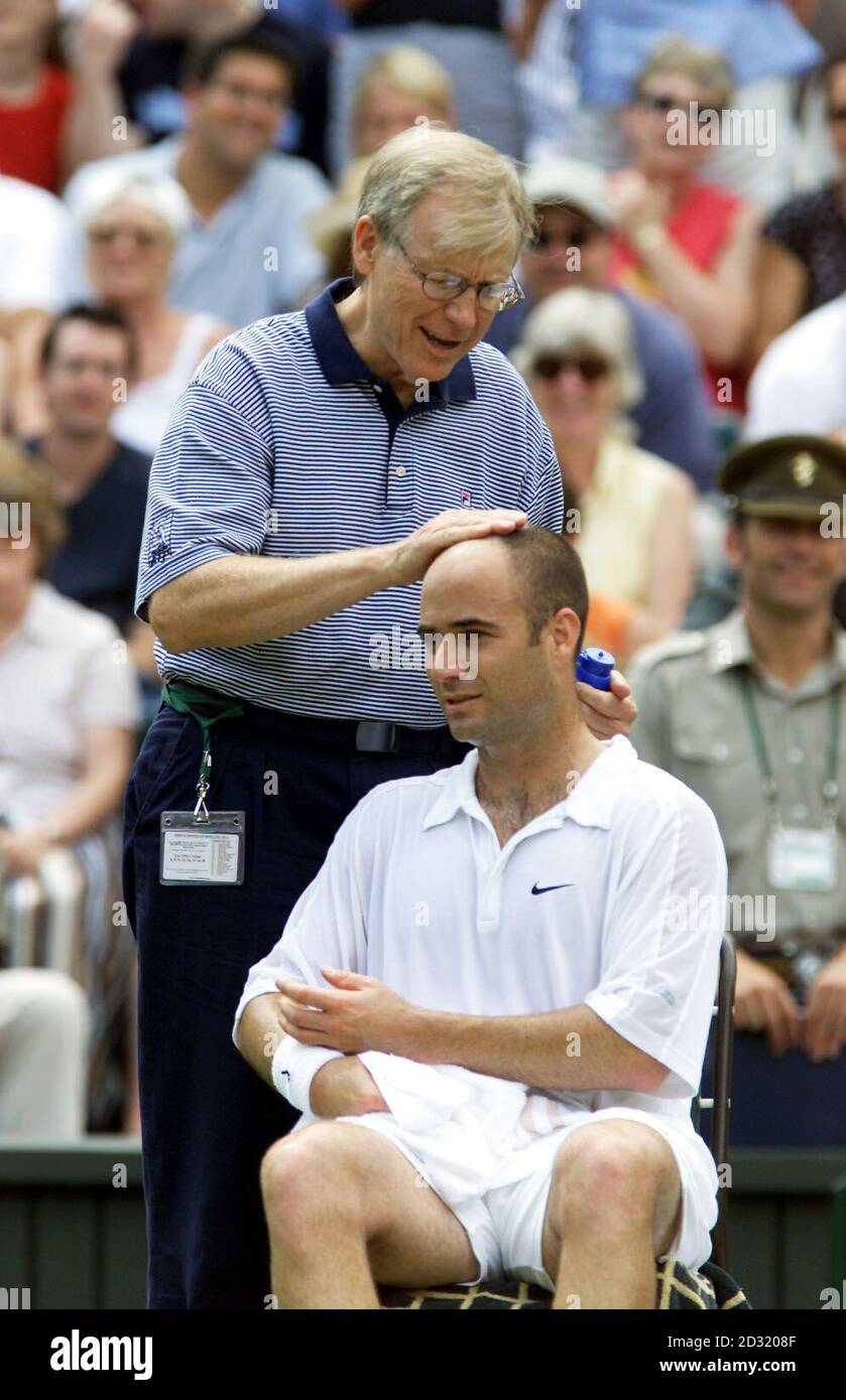 NO COMMERCIAL USE: USA's Andre Agassi has sun cream rubbed into his ...