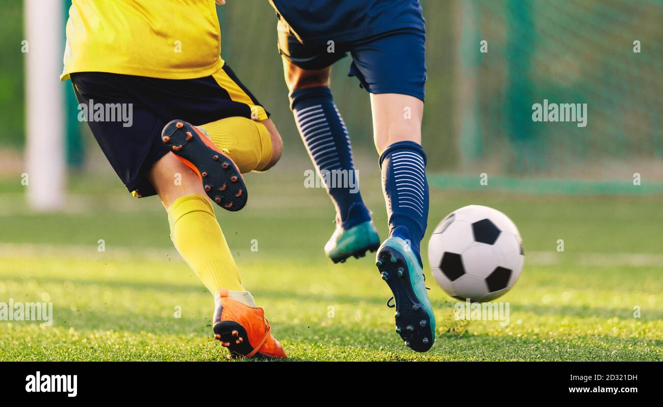 Close-up of Two Youth Footballers Running in a Duel. Soccer Players in ...