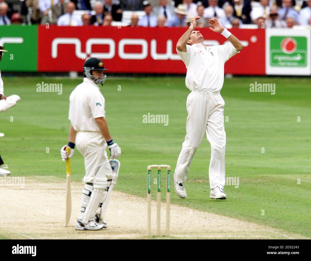 England's bowler Andrew Caddick (right) holds his hands up in ...