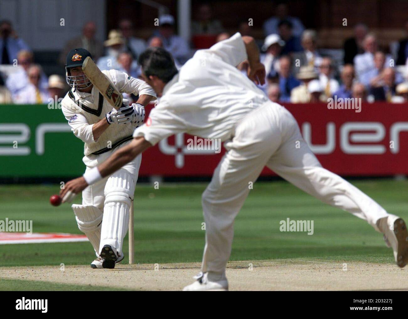 Australia's Damien Martyn drives off and past England bowler Andrew ...