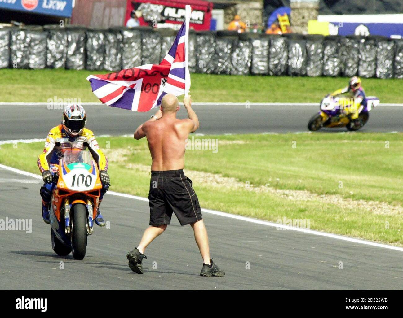 Great Britain's Neil Hodgson is given a flag by a fan after coming ...