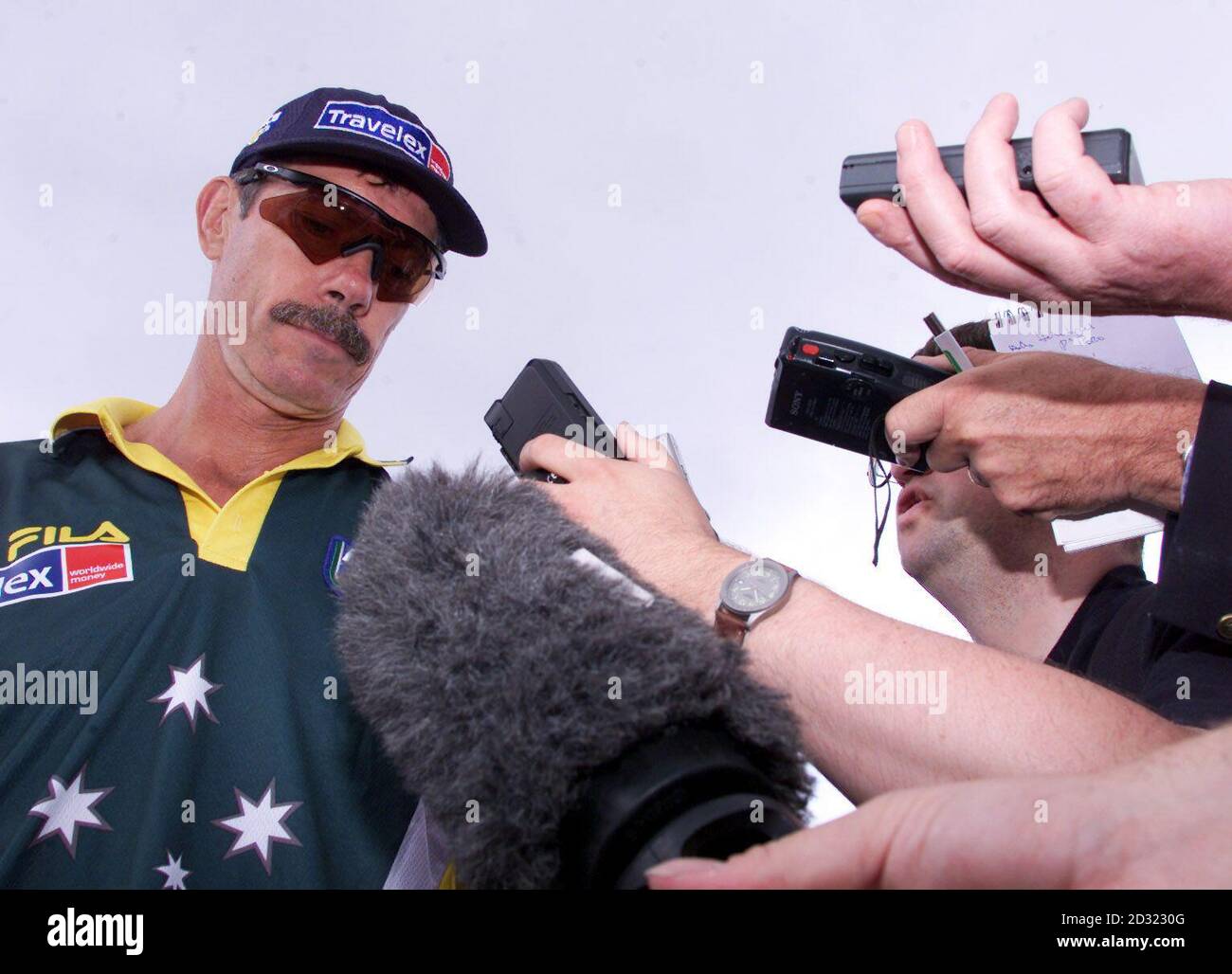 Sport cricket cap sunglasses shades camera journalist microphone hi-res ...