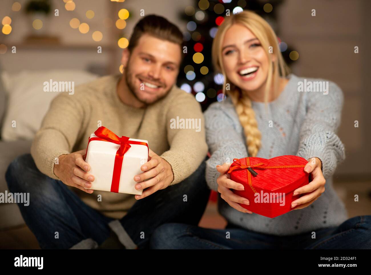 Happy couple celebrating Christmas together at home Stock Photo - Alamy