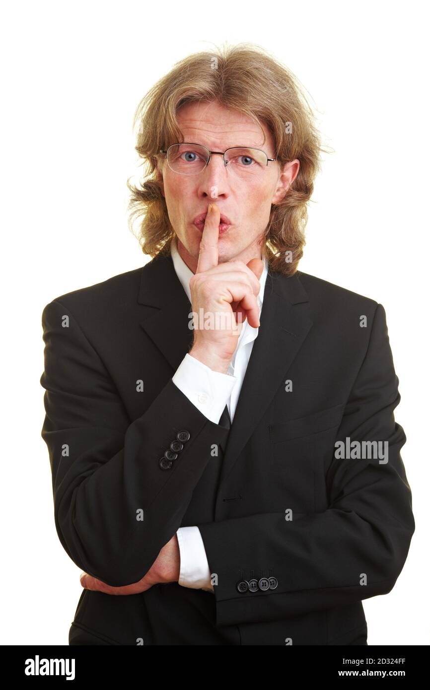 Businessman puts his index finger on his lips Stock Photo - Alamy