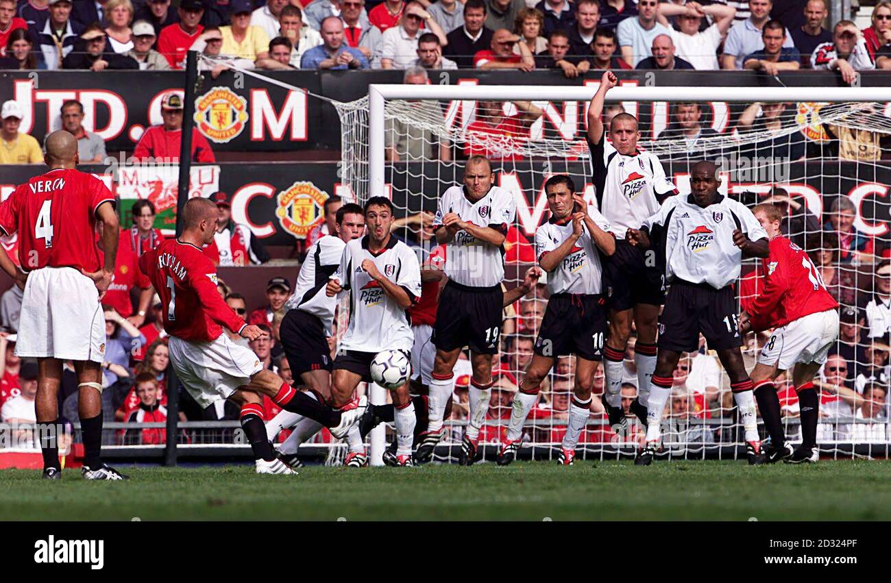 Manchester United's David Beckham (left) curls in a free kick over the ...