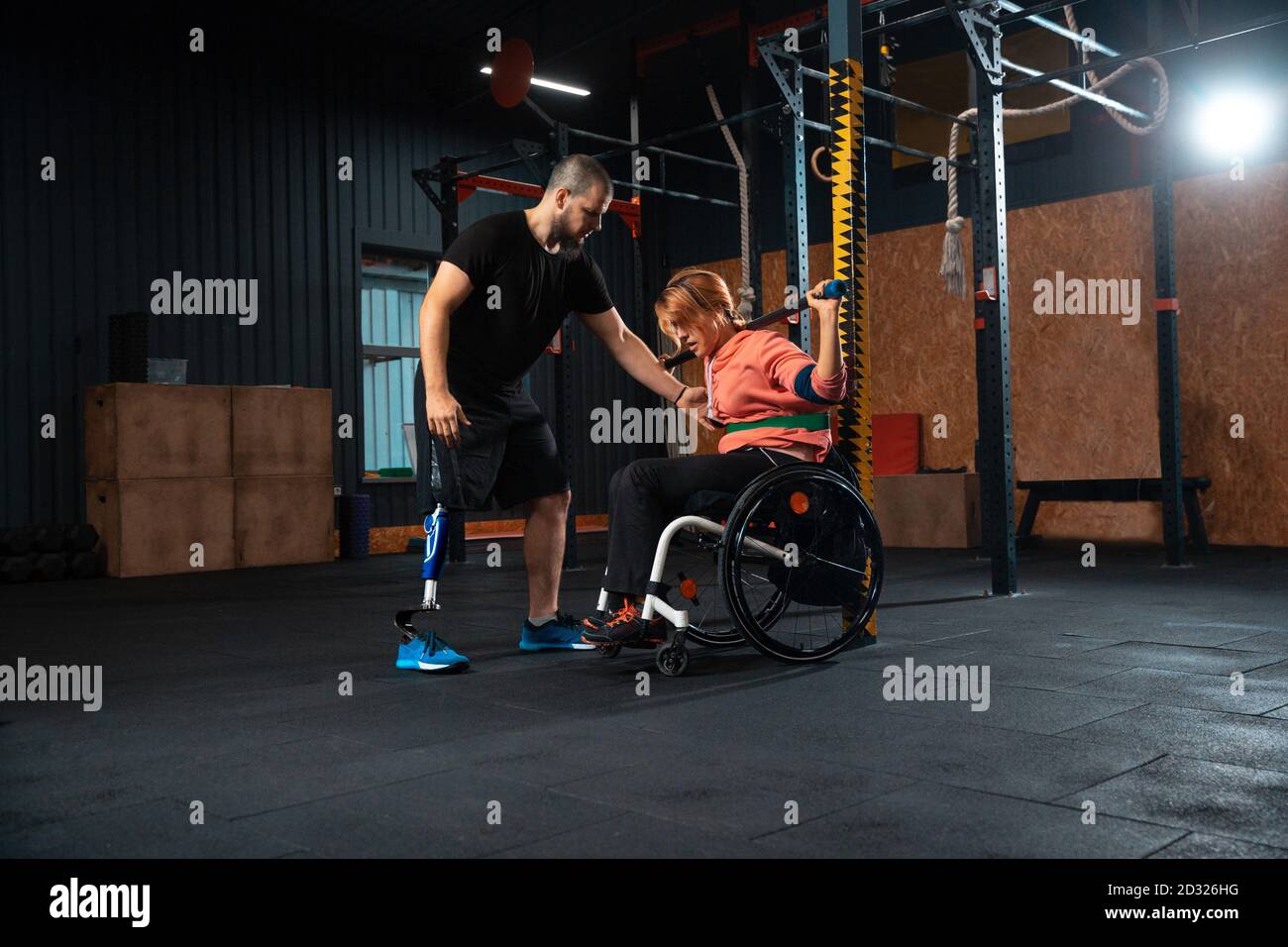 Barbell. Disabled woman training in the gym of rehabilitation center ...