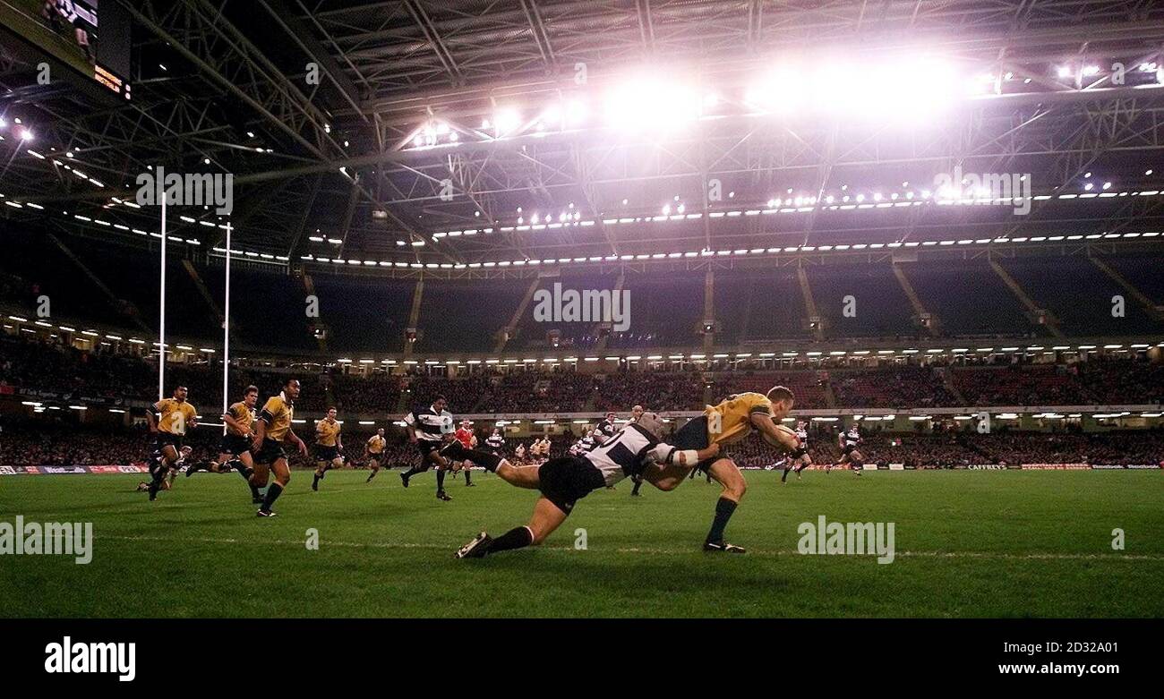 Australia's Chris Latham (right) is tackled by Braam van Sraaten of the ...