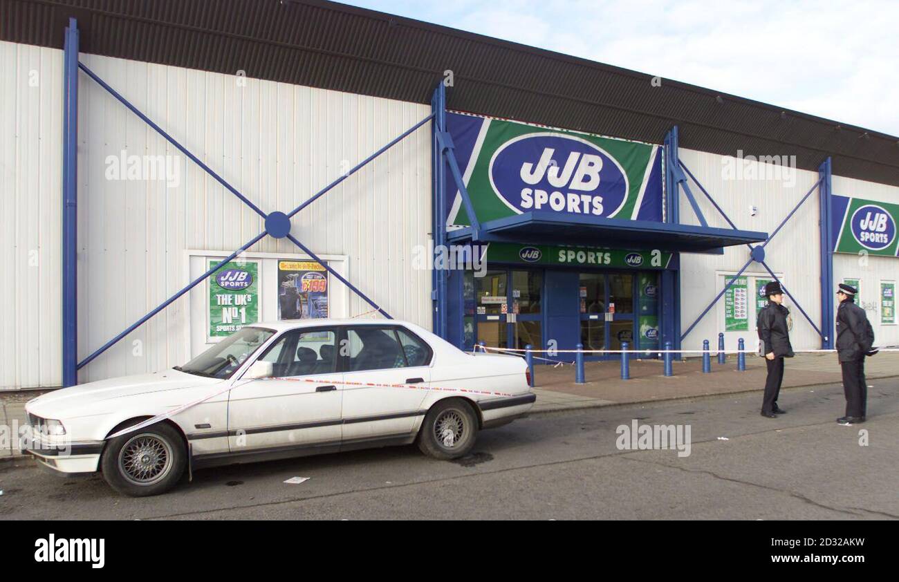 Police officers stand outside the JJB sports in Alpine Way, Beckton ...