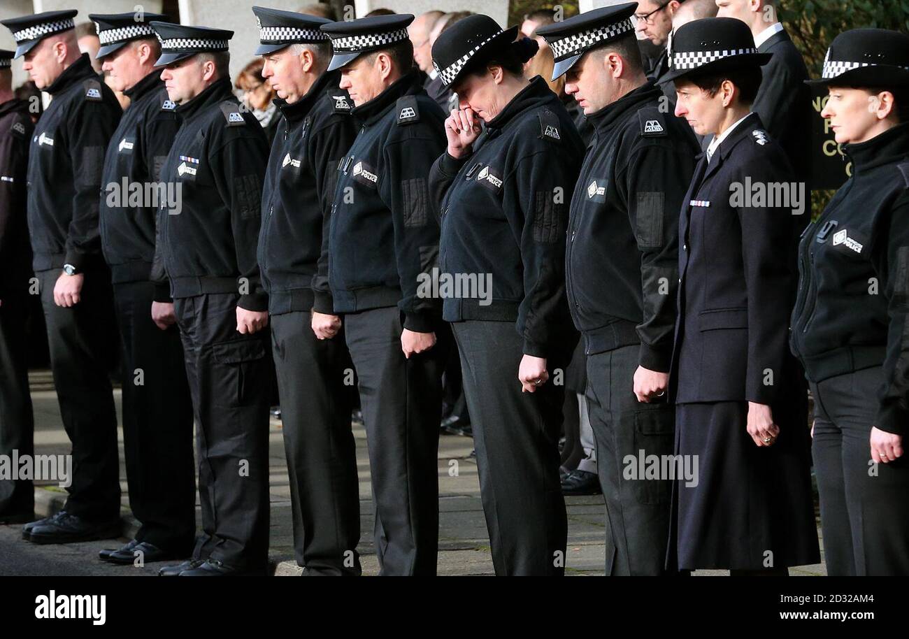 Police officers line up to show their respect as the cortege carrying ...