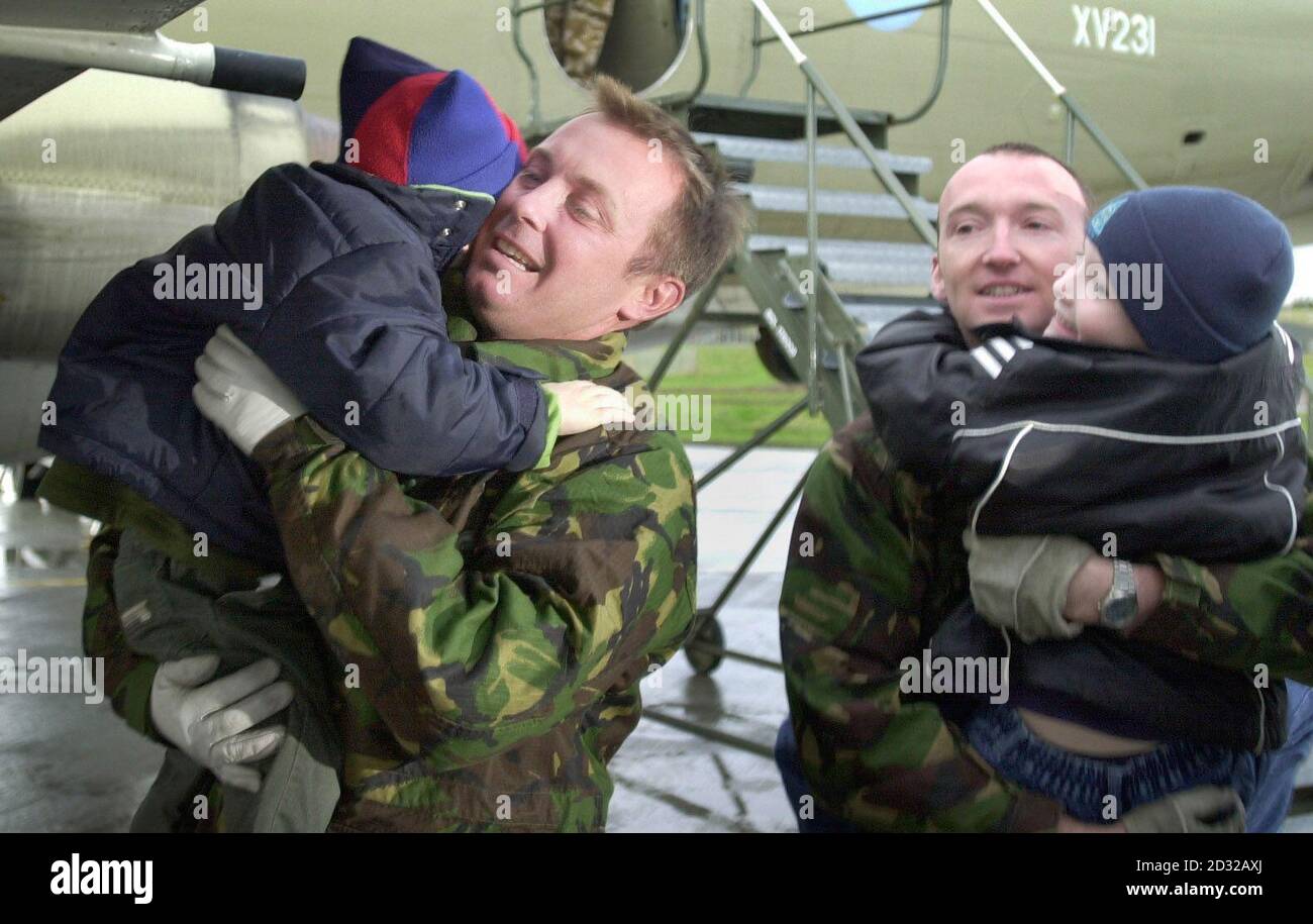Corporal Andrew Fish (right) holds his son Daniel, 6, as he and a crew ...
