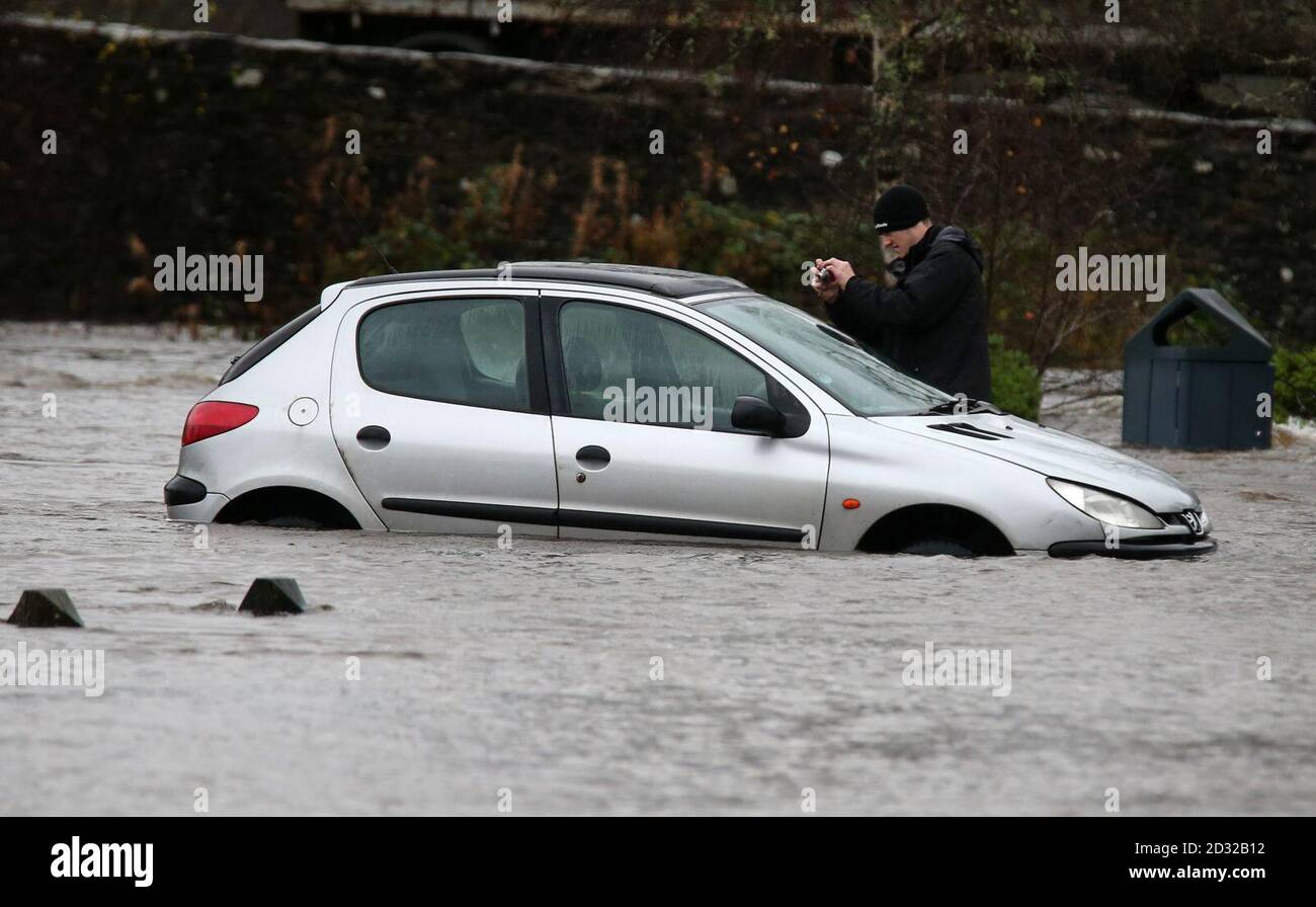 A person takes a picture of a car in a car park in Aberfoyle, which has ...