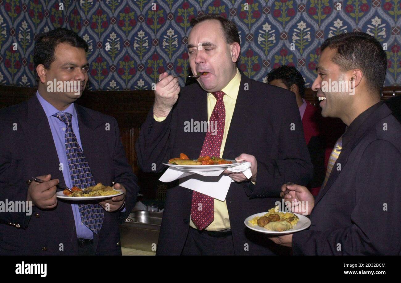 Alex Salmond (centre) tucks into some Indian cuisine with a former ...