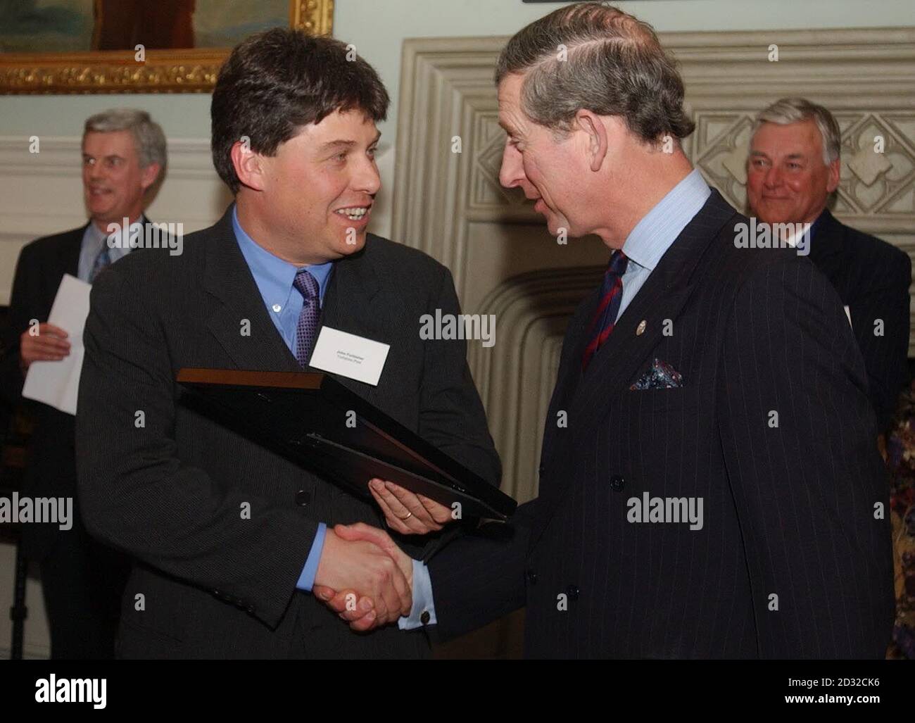 John Furbisher accepts an award on behalf of Maggie Stratton, from The ...