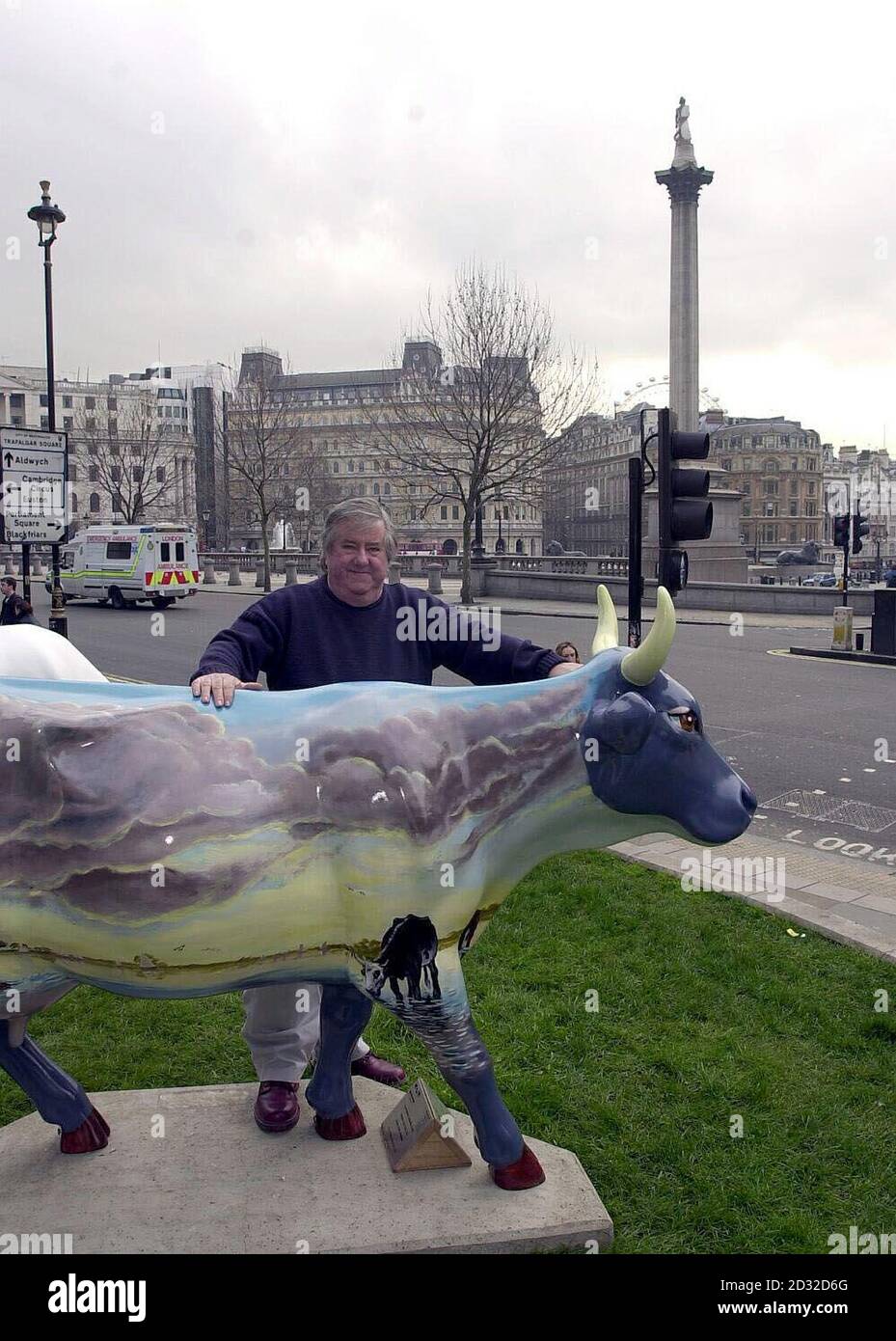 Artist Keith Wallace Tuesday March 5, 2002, with the cow he painted as ...