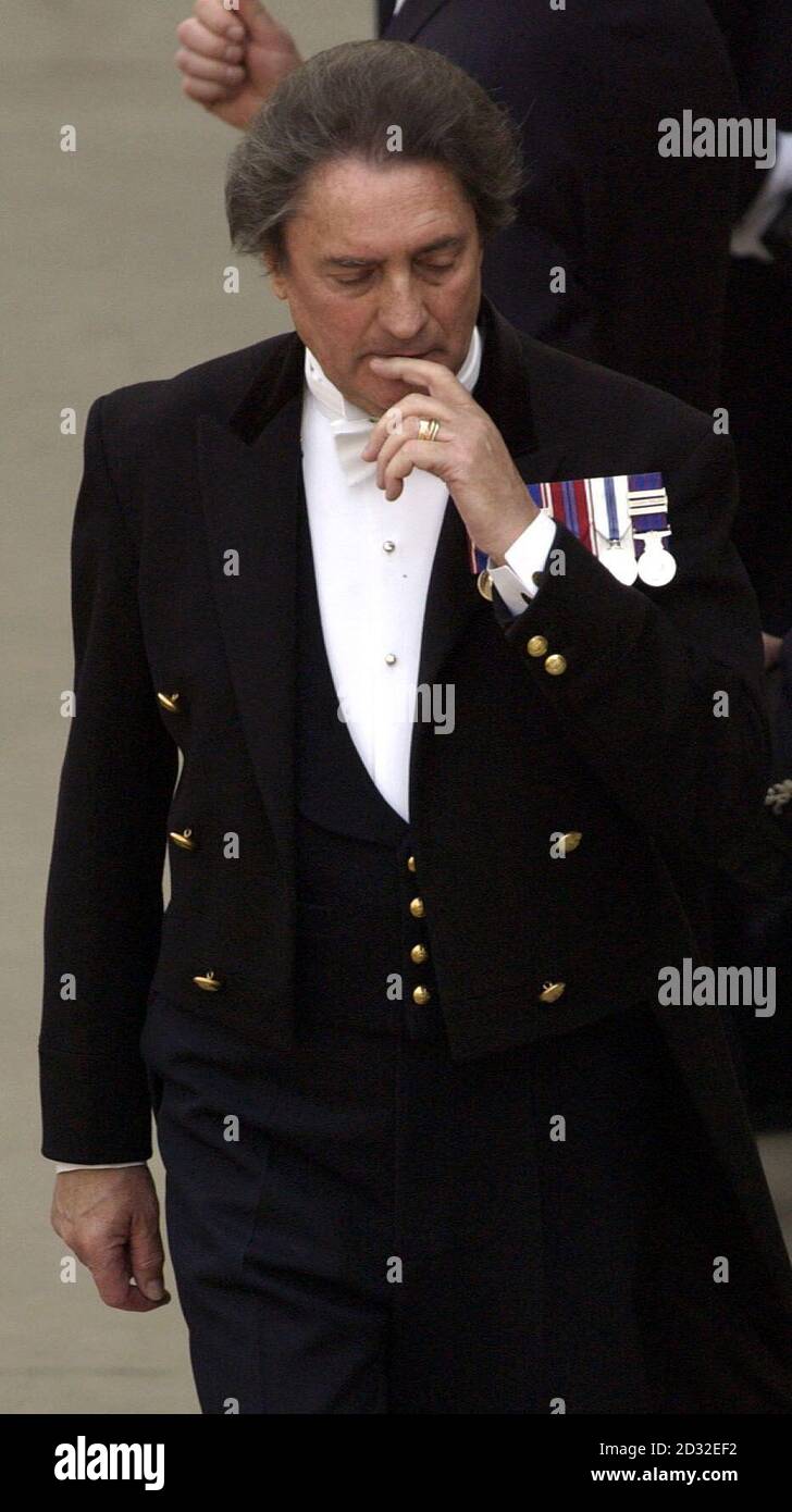 Billy Tallon, one of the Queen Mother's staff, leaves Westminster Hall ...