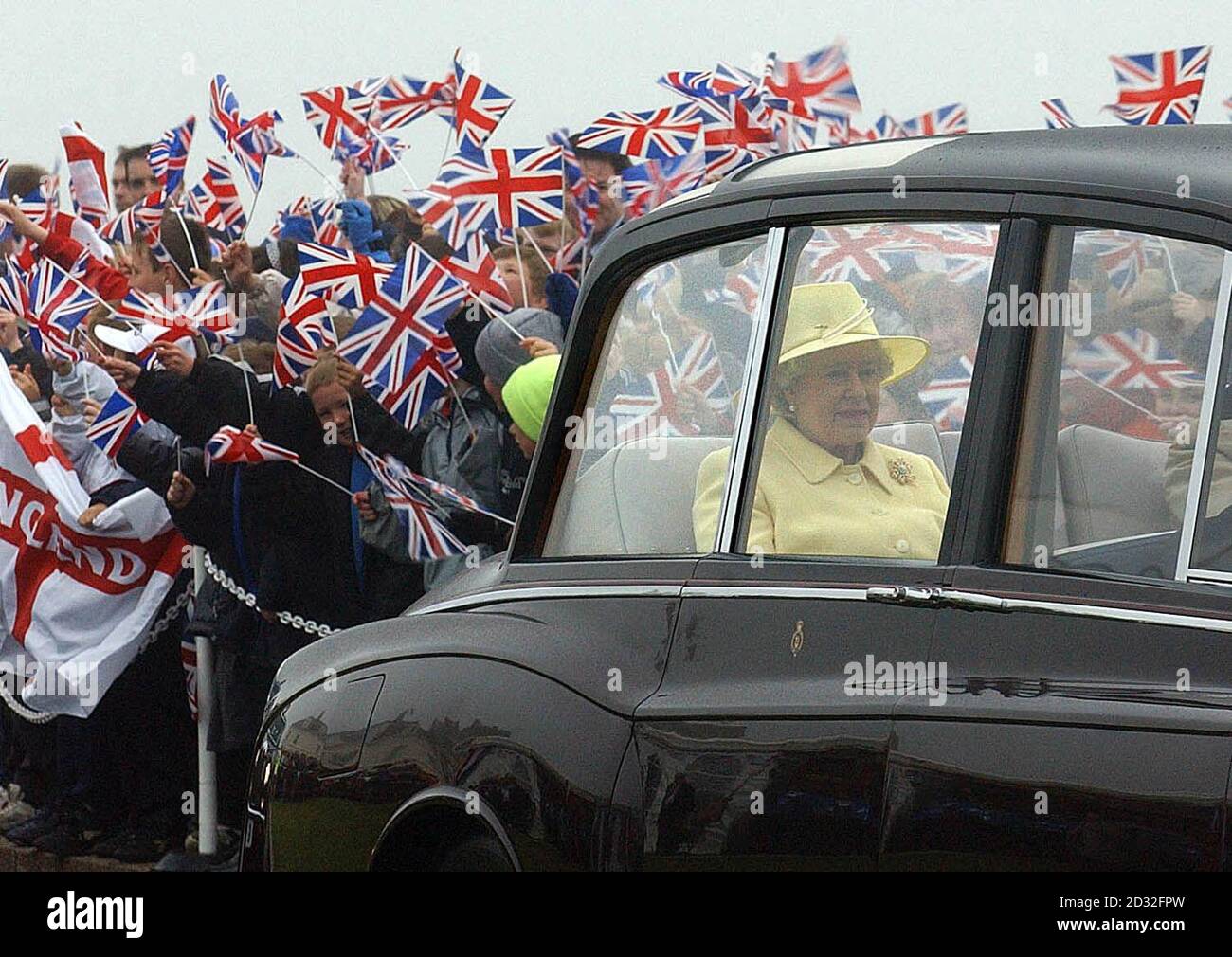 The crowd wave their Union Jack flags as The Queen leaves Seaham ...