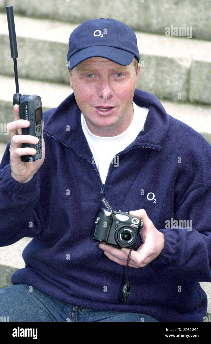 British explorer Dave Mill poses with his mobile satellite phone and ...