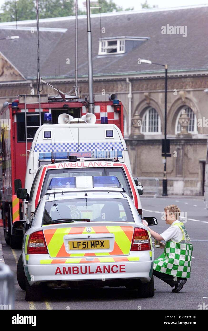 Emergency service vehicles wait in a street by Buckingham Palace in ...