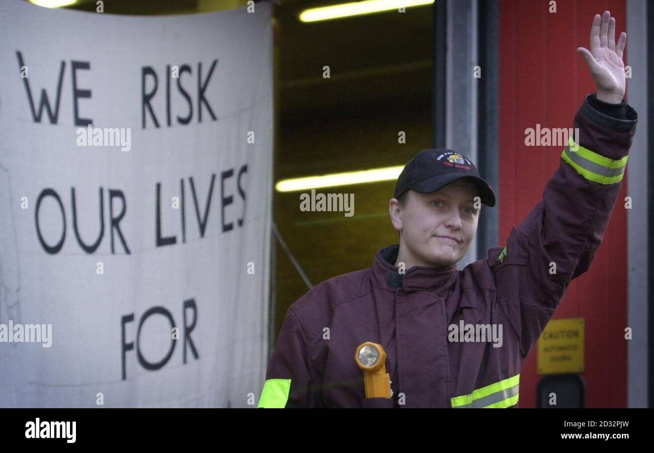 Firefighter Bec Bray acknowledges motorists sounding their horns as ...