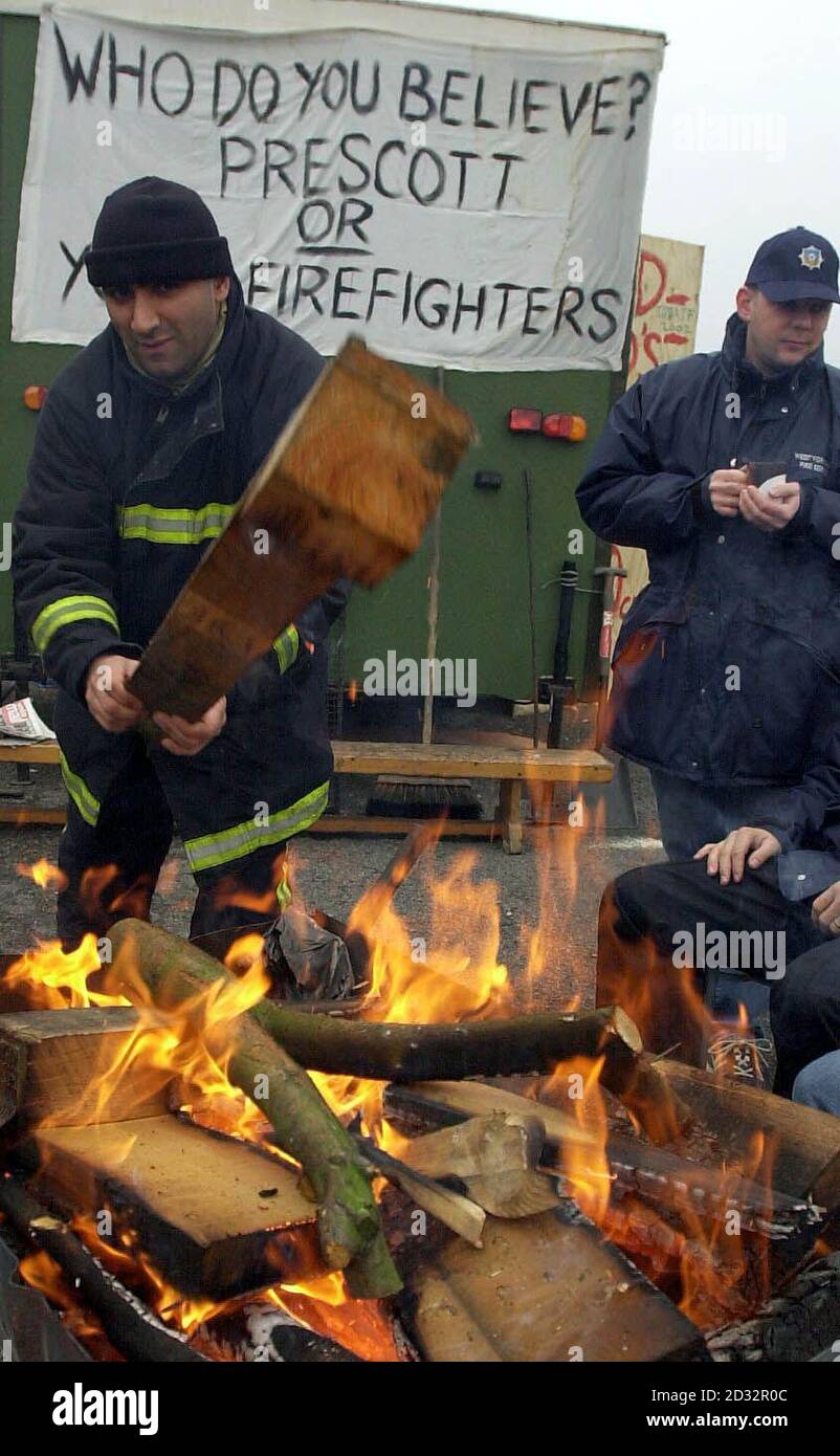 Firefighters feed a bonfire on their picket line at Bramley Fire ...