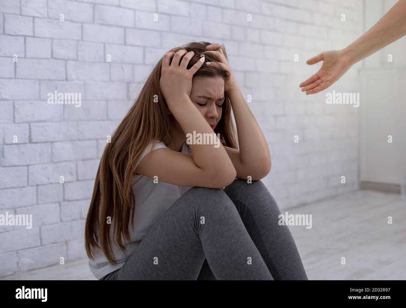 Psychologist hand helping sad young woman to get rid of depression ...