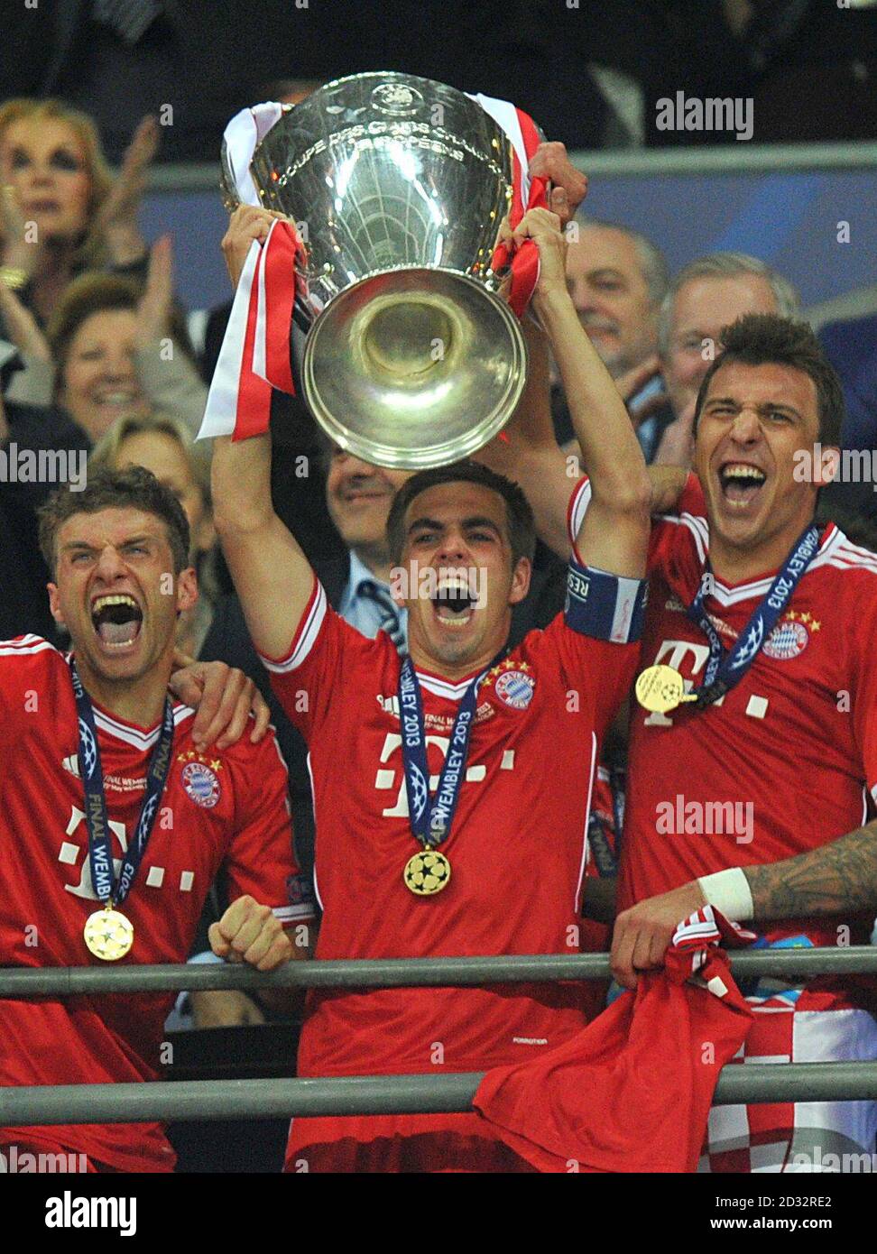 Bayern Munich's Philipp Lahm lifts the UEFA Champions League trophy ...
