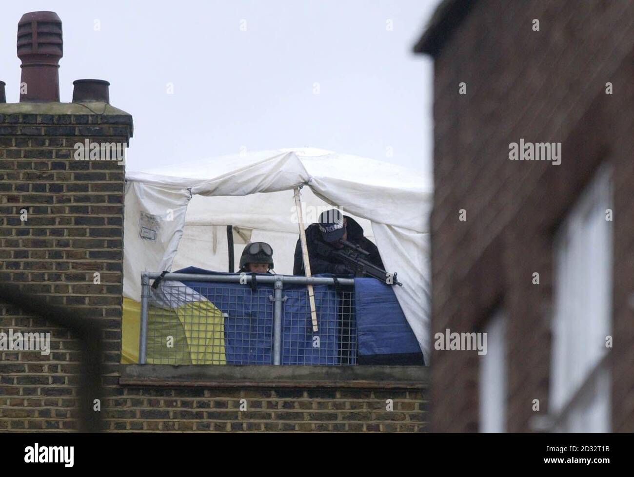 A police marksman in position in Hackney, East London on the eighth day ...