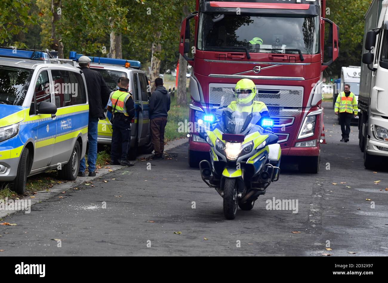 Cologne, Germany. 07th Oct, 2020. A policeman drives in front of a ...