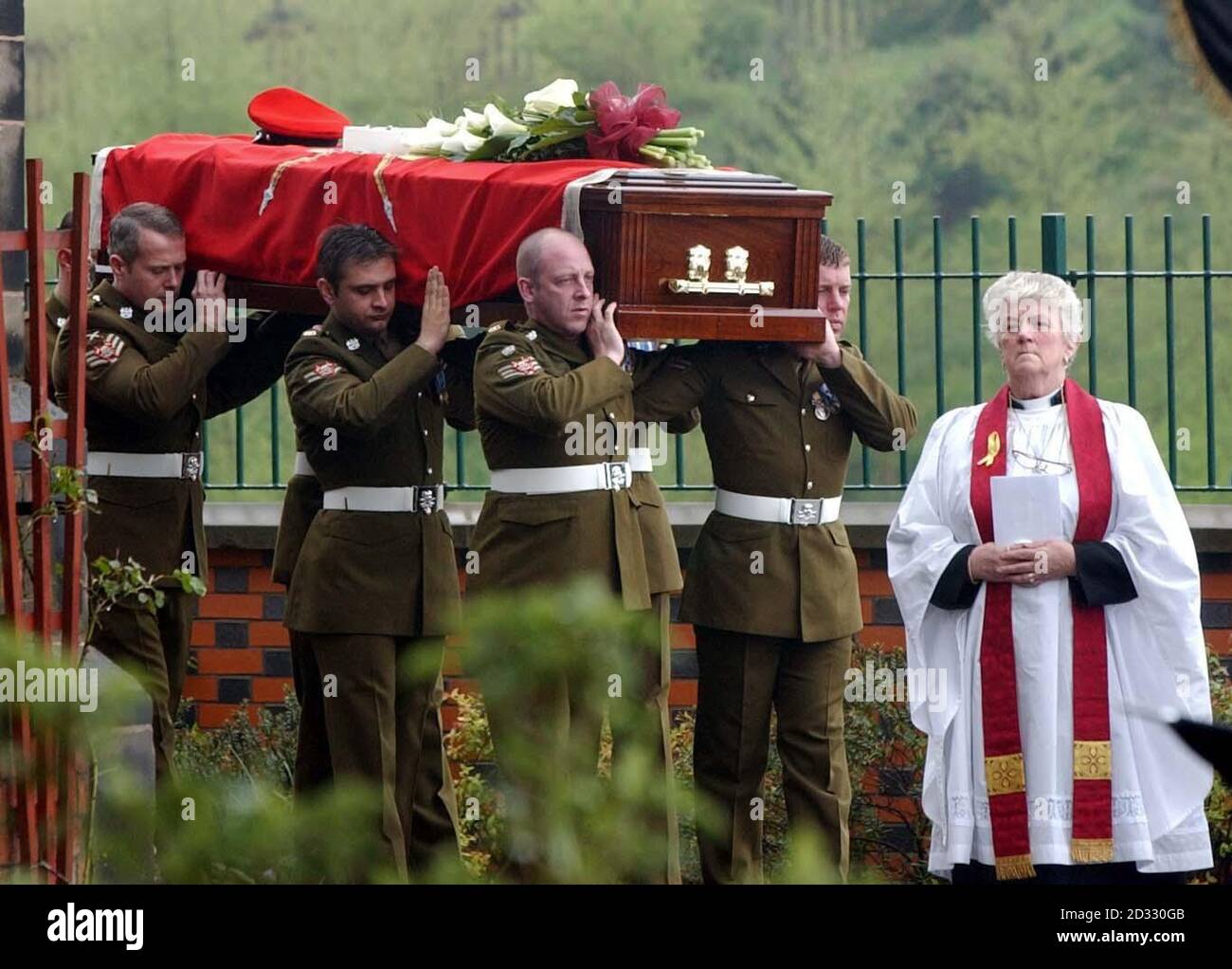The coffin of Corporal Stephen Allbutt is carried behind Revd Mavis ...