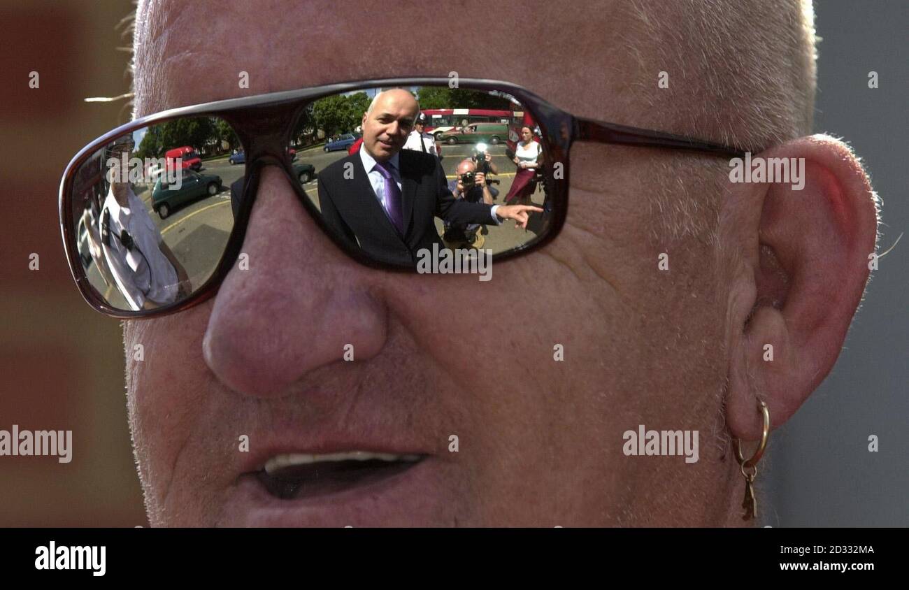 Conservative leader Iain Duncan Smith is reflected in the sunglasses of ...