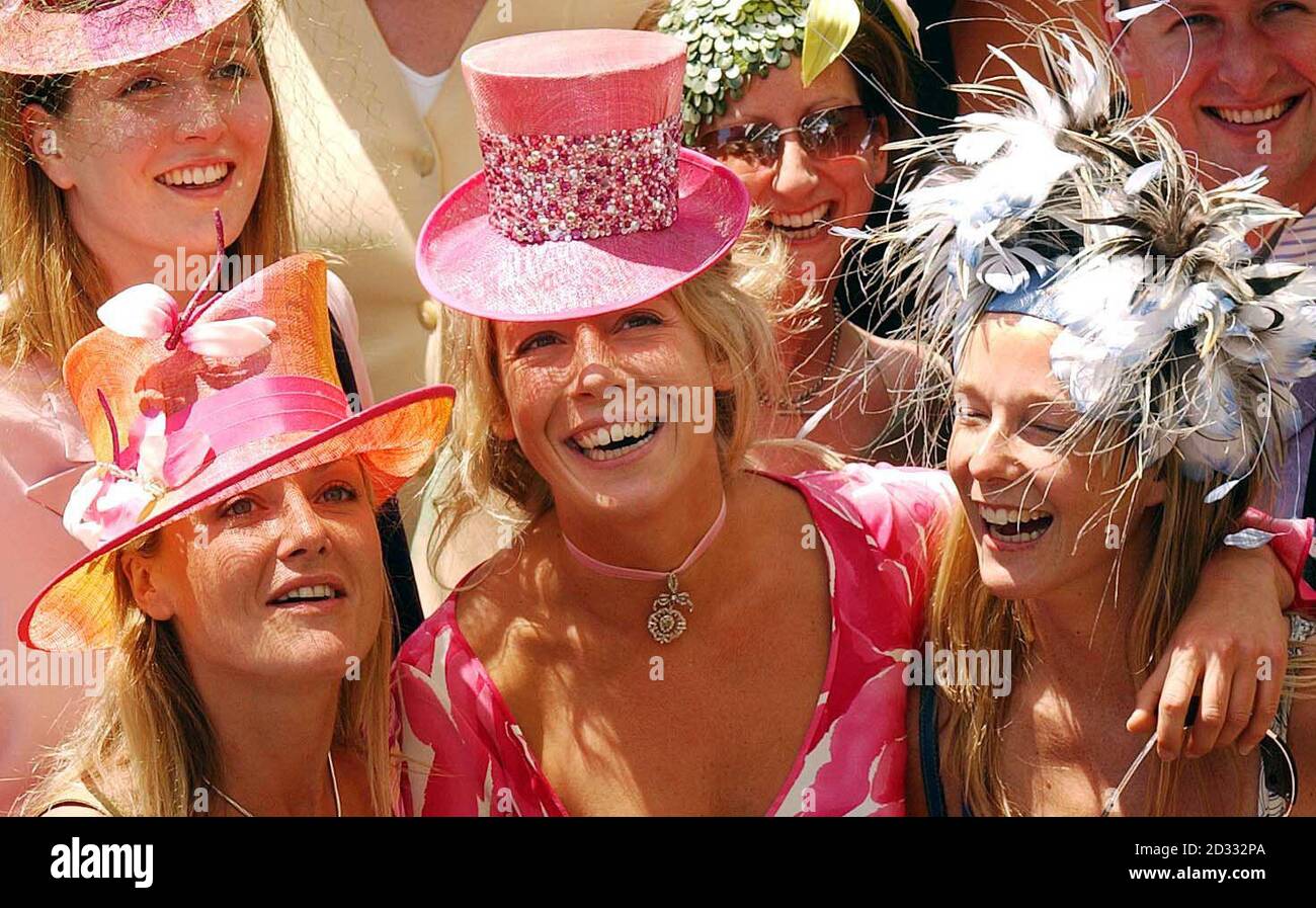 A group of female race fans study the odds, during the 4th day of the ...