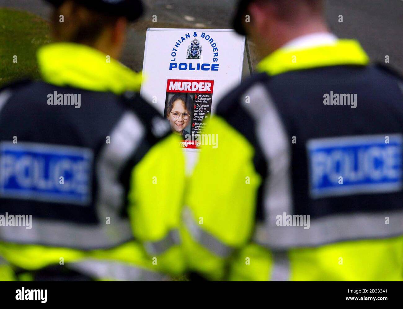 Police officers stand by a mobile incident van, in Dalkeith, Scotland ...