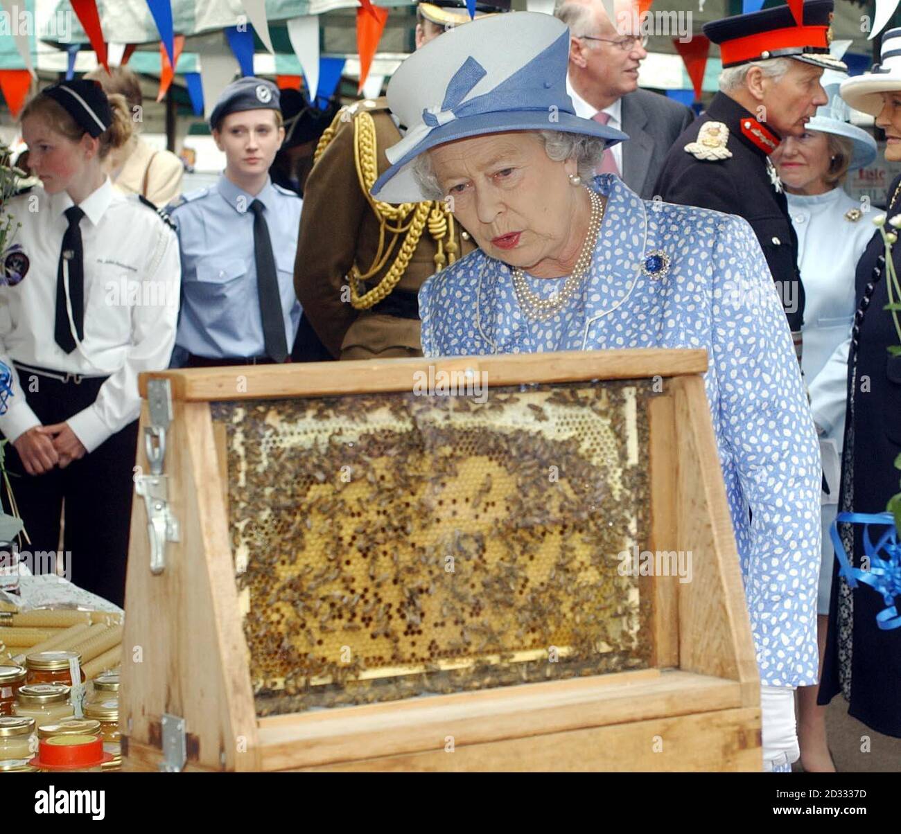 Queen Elizabeth II searches for the queen bee on the Hill House Farm ...