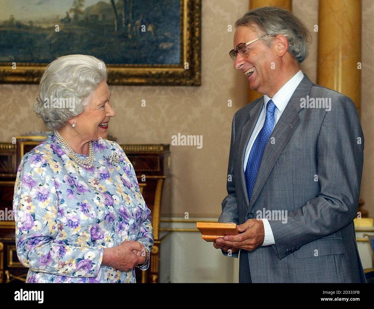 Britain's Queen Elizabeth II receives Professor Dan McKenzie, investing him with the Insignia of ...