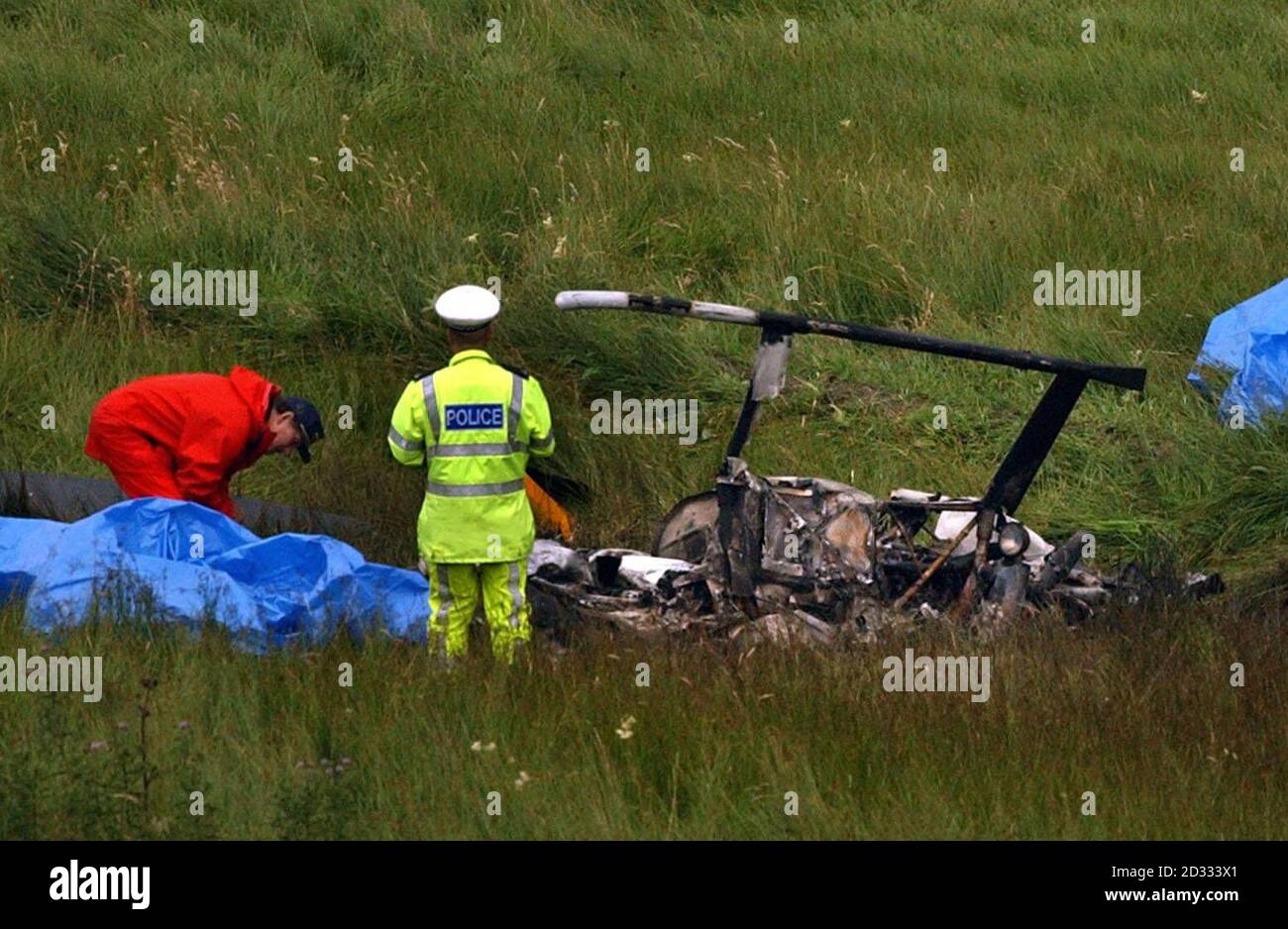 Police view the site of a helicopter crash which claimed the life of ...