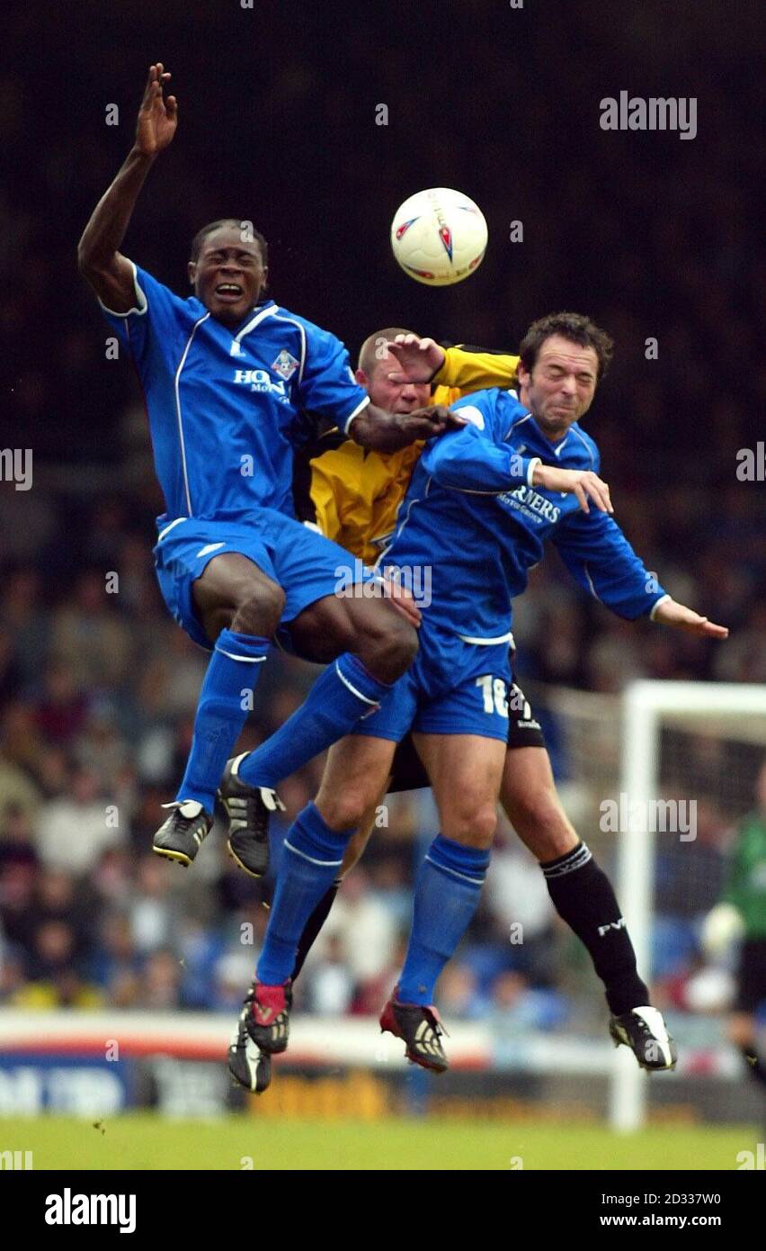 Port Vale's Neil Brisco is sandwiched between Oldham Athletic's Calvin ...