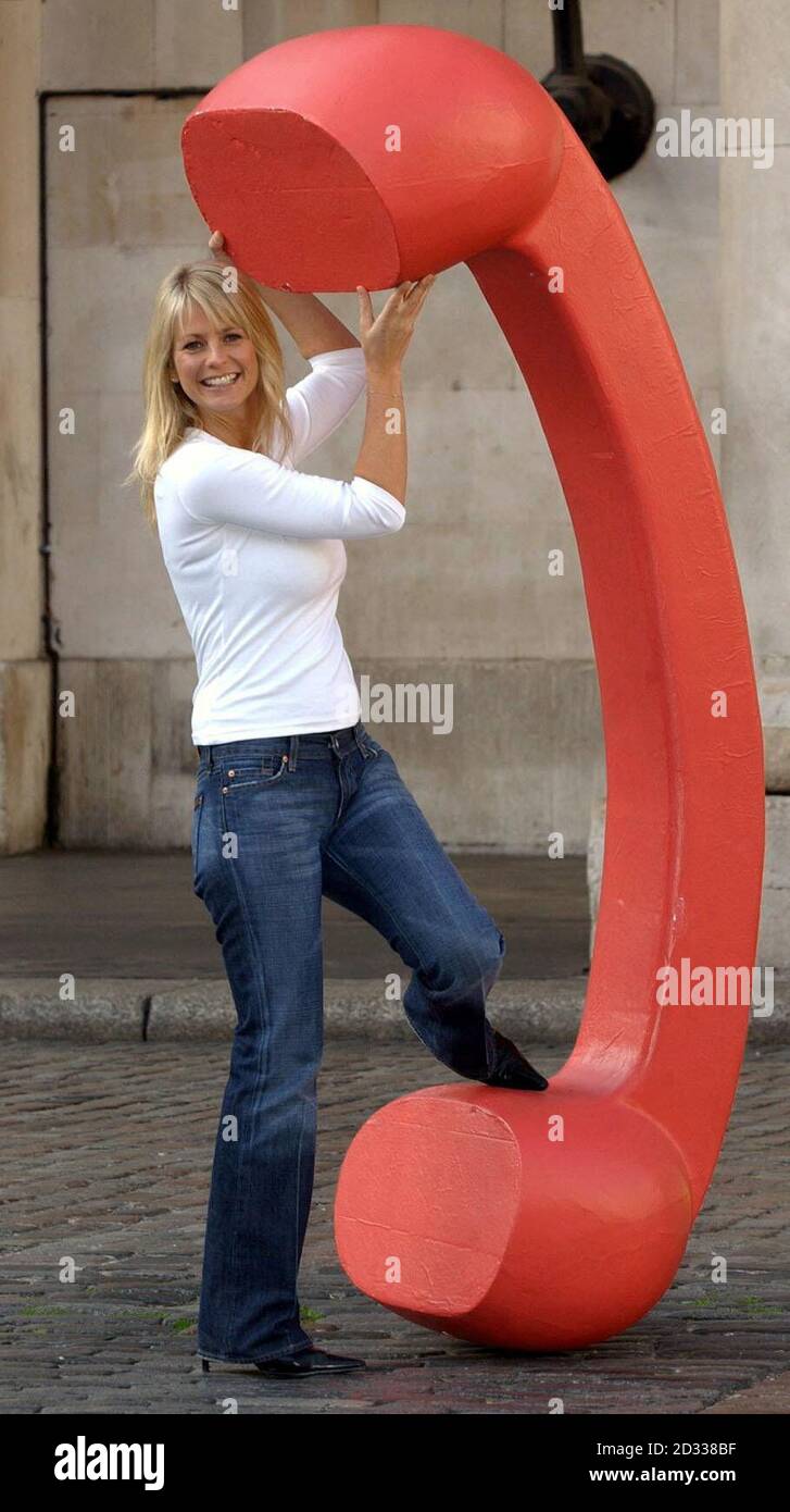 TV presenter Ulrika Jonsson poses for photographers with a giant phone ...