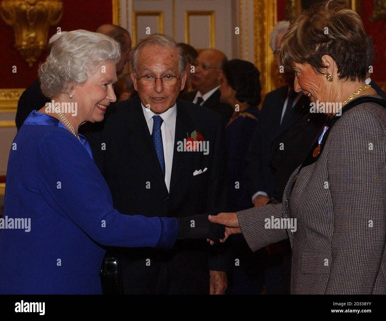 Britain's Queen Elizabeth II meets Mrs Cyril Reitman, watched by The ...