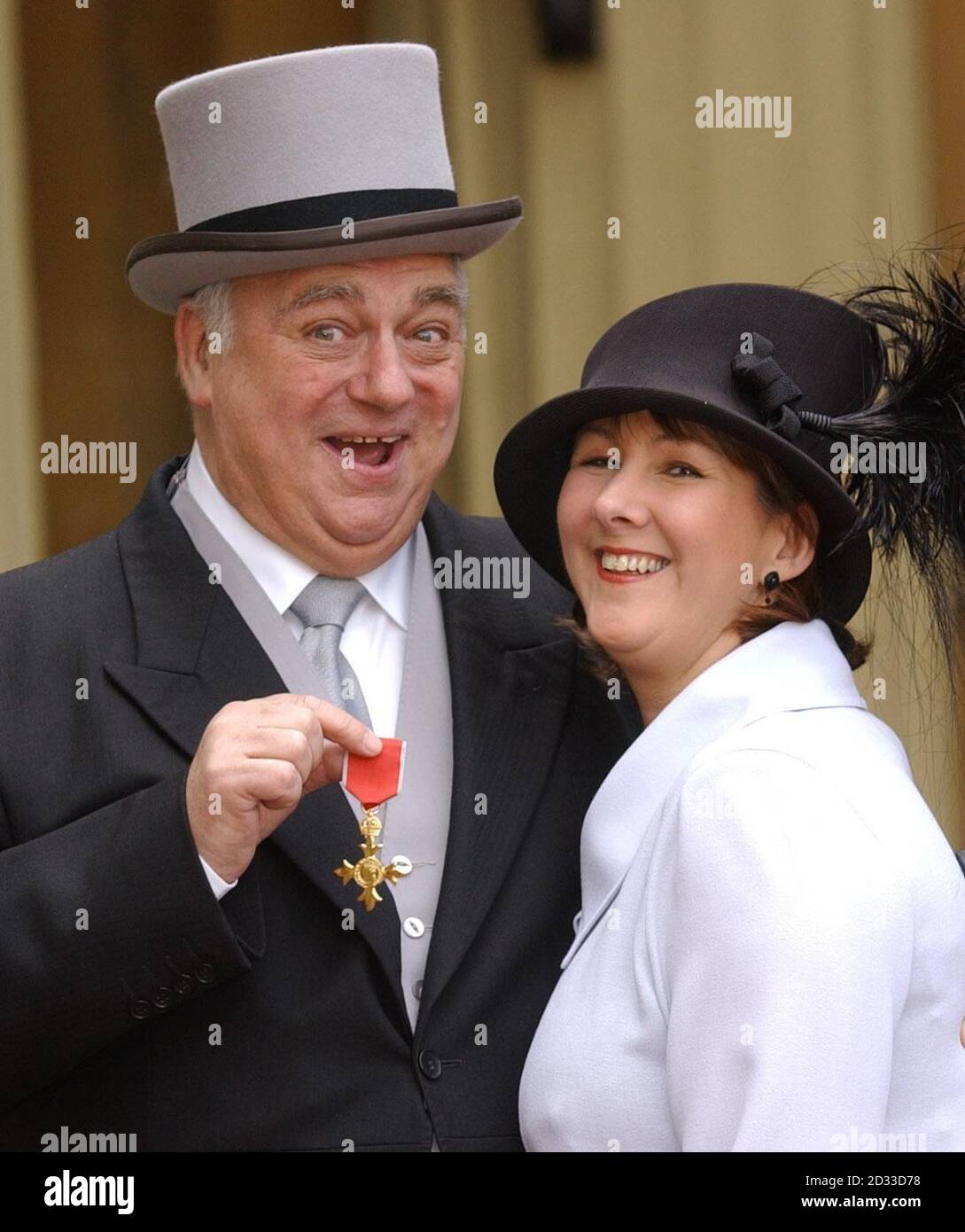 Comedian Roy Hudd with his wife Debbie, holds his OBE for services to ...