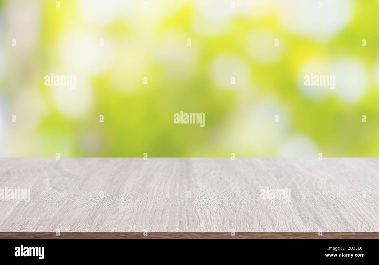 Tabletop made of wood with the blurred background of leaf bokeh, used ...