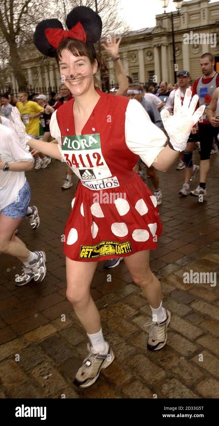 A runner dressed as Minnie Mouse runs at the start of the 2004 London ...