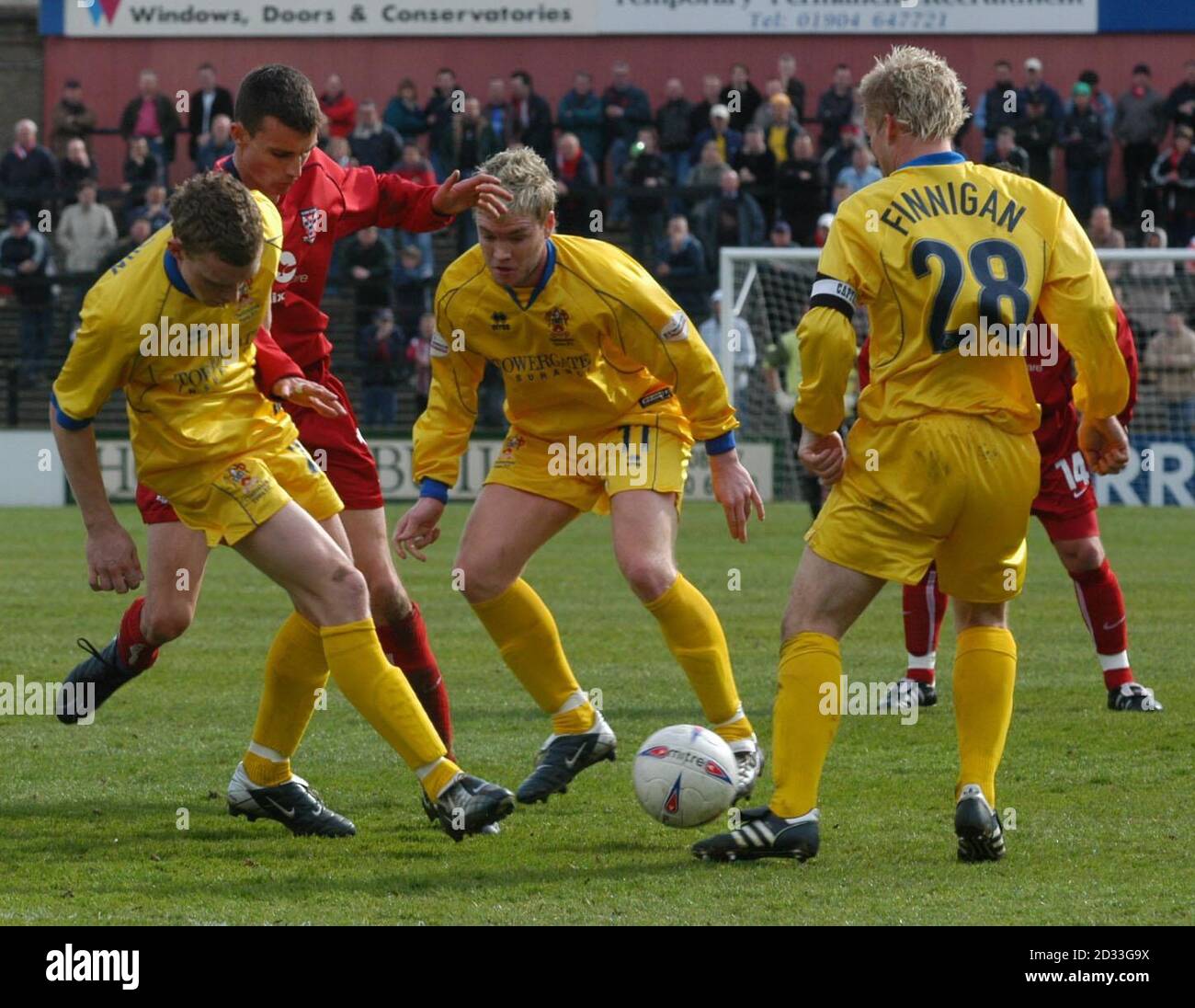 Jon Newby of York City (red) battles his way through the Cheltenham ...
