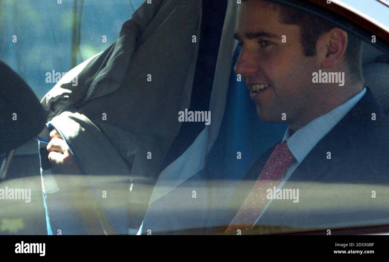 Tim Rattigan (under blue jacket) is driven away from Tallaght District ...