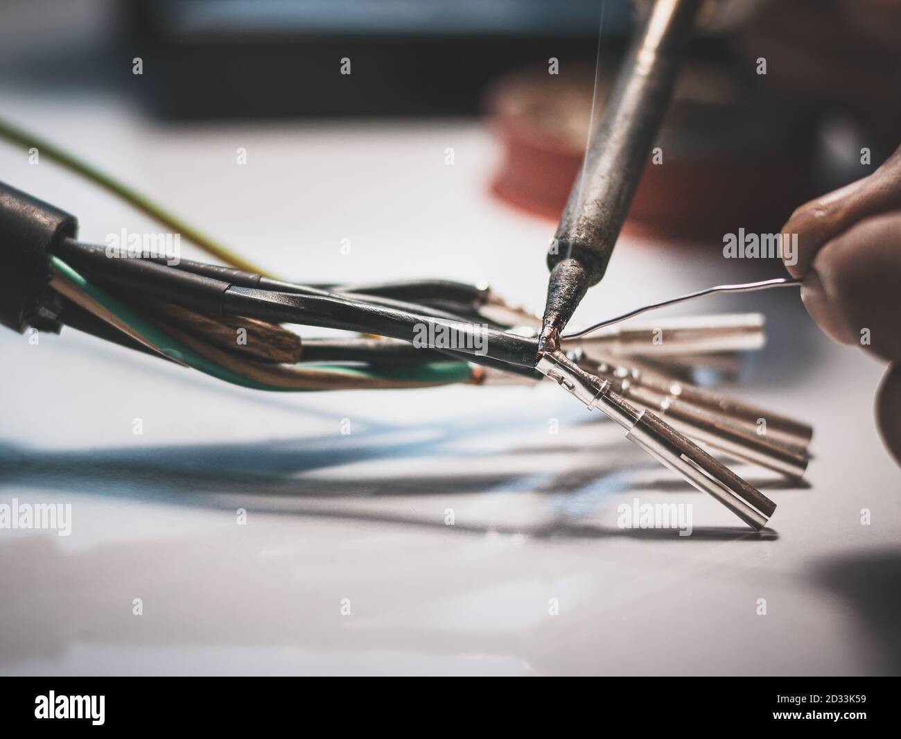 Electricians are using a soldering iron to connect the wires to the ...