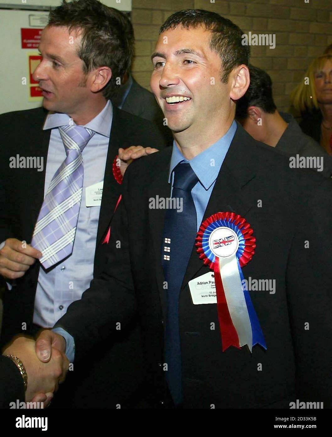 The British National Party's Adrian Paul Marden smiles after holding ...